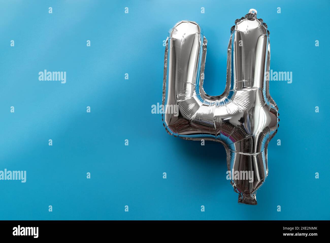 4 four metallic balloon isolated on blue background. Greeting card ...