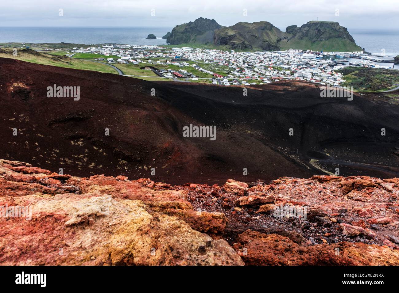 The city of Heimaey and the haven are located at the foot of the ...