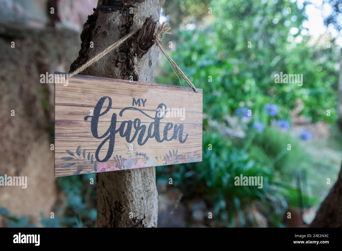 Garden sign with mediterranean courtyard as background. English ...
