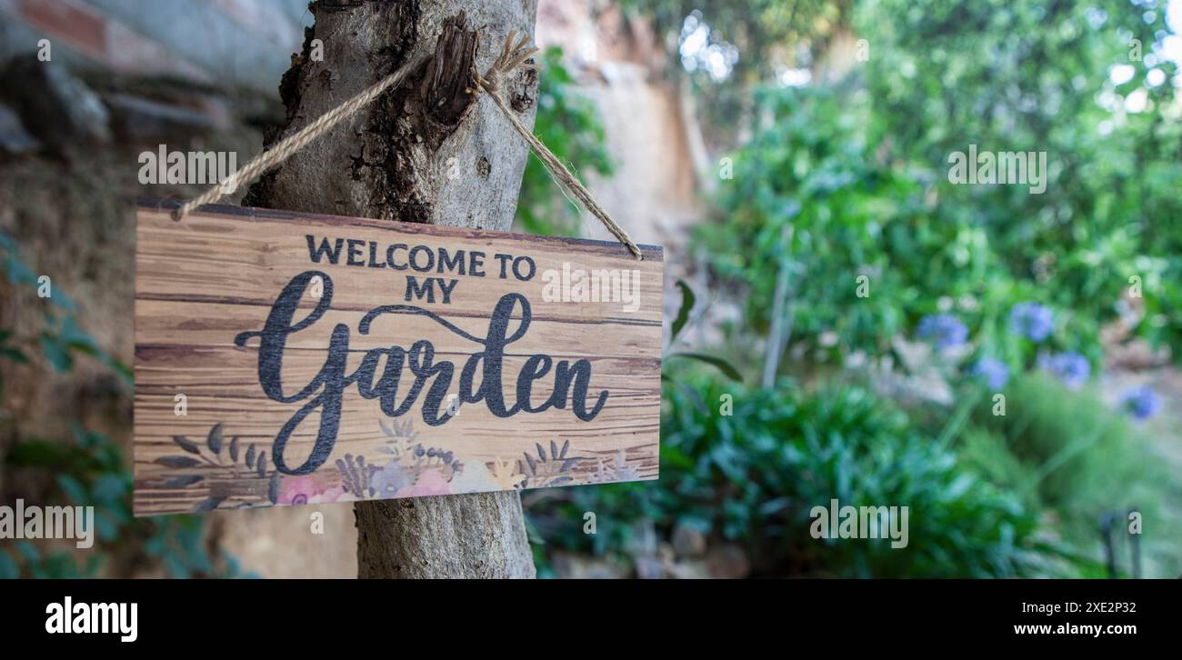 Garden welcome sign with mediterranean courtyard as background. English ...