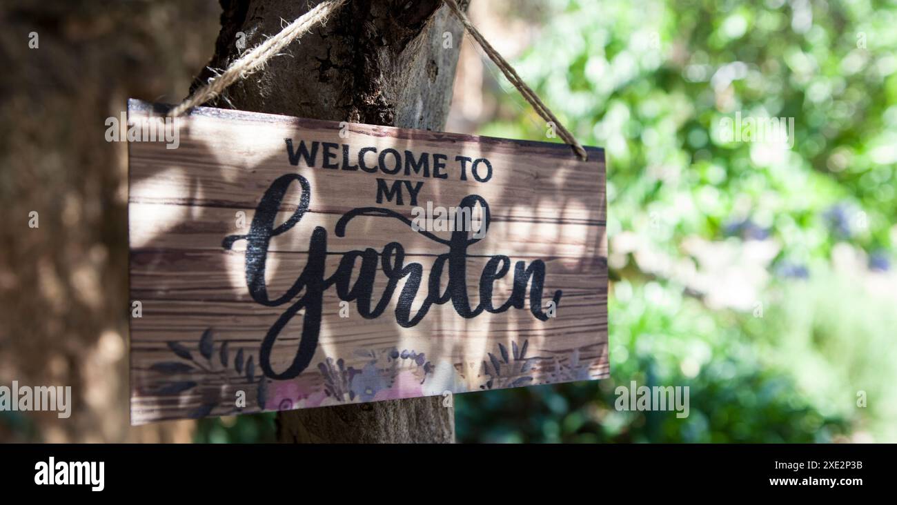 Garden welcome sign with mediterranean courtyard as background. English ...