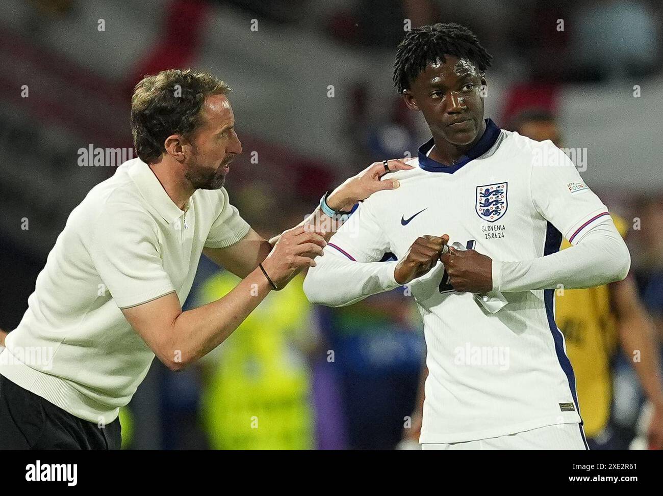 England manager Gareth Southgate (left) speaks to Kobbie Mainoo on the ...