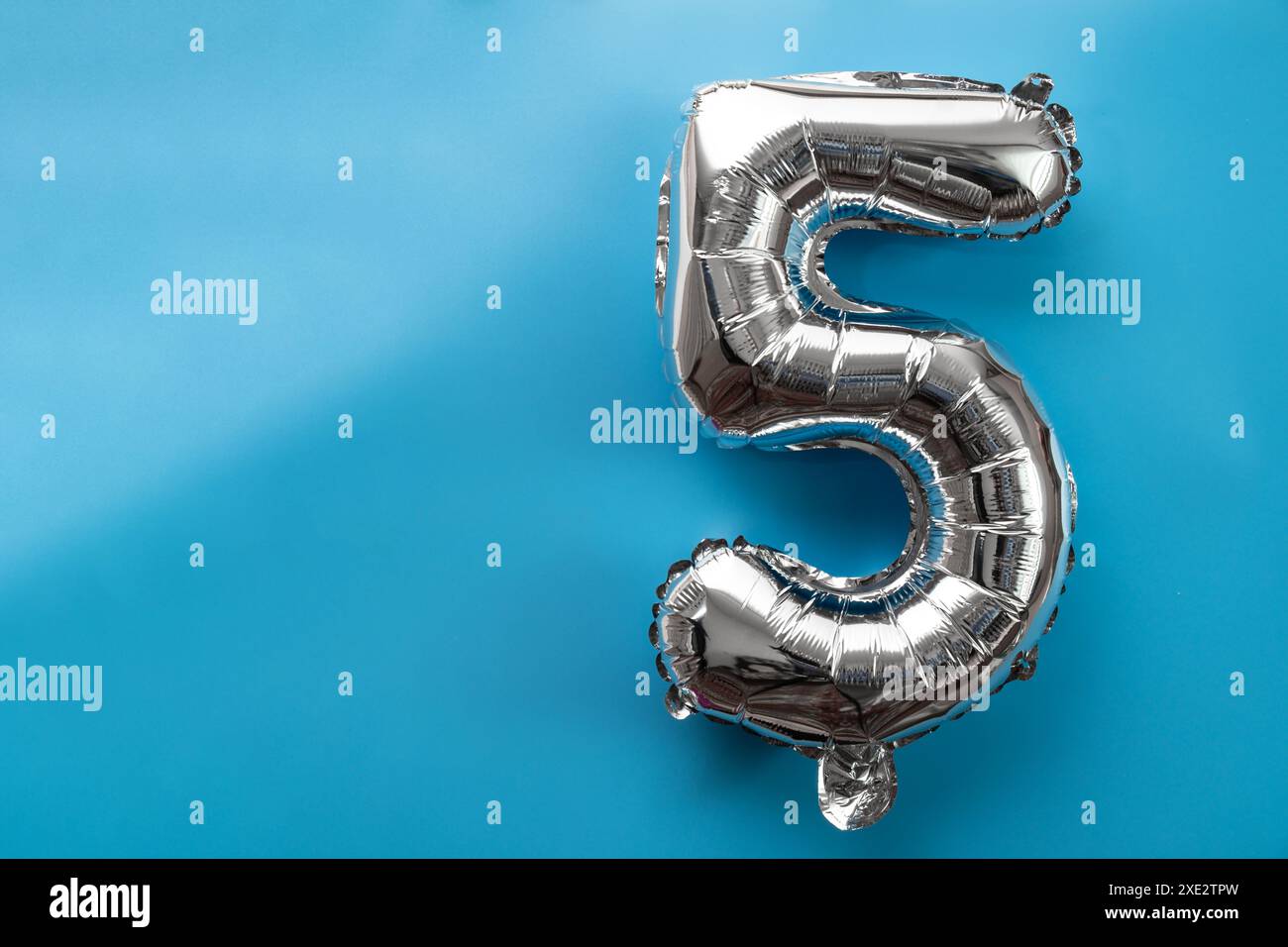 5 five metallic balloon isolated on blue background. Greeting card ...