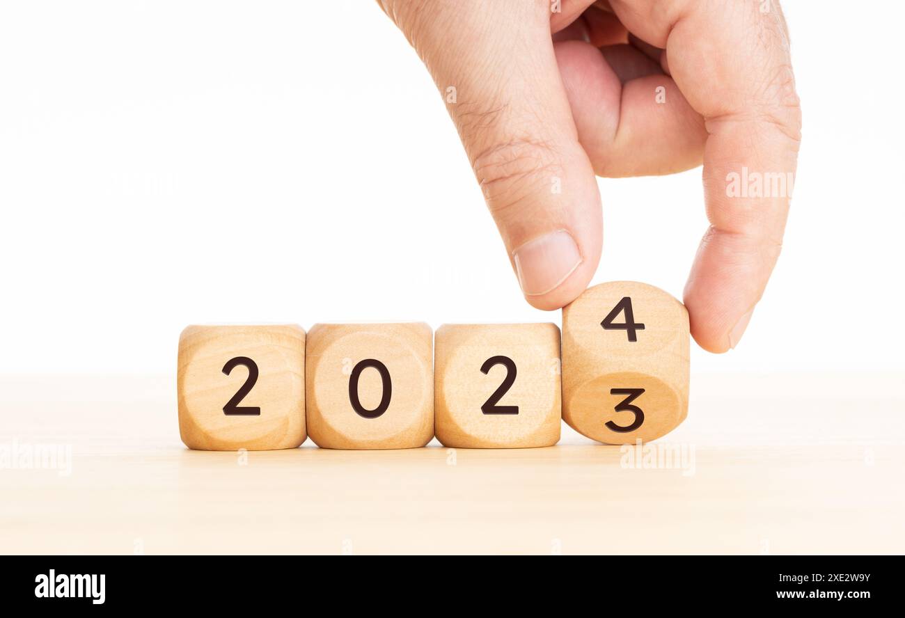 New year concept. Hand flips Wooden Blocks from 2023 to 2024 year. Copy ...