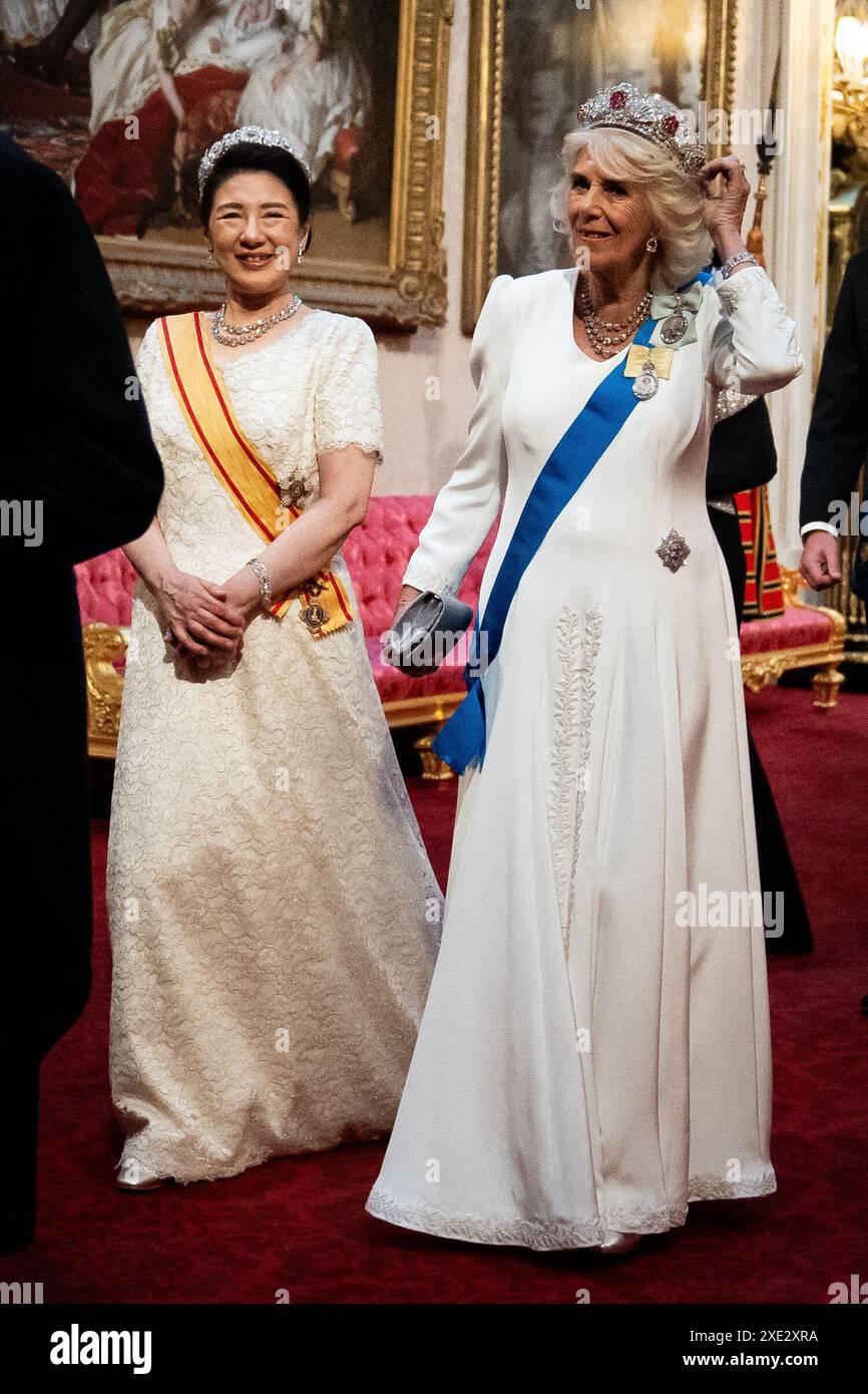Empress Masako and Queen Camilla make their way along the East Gallery ...