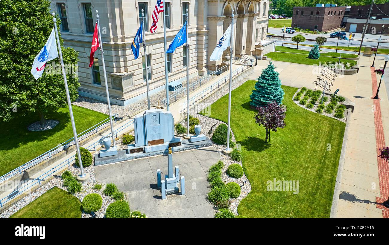 Aerial View of Memorial with Flags and Stone Monument in Urban Park ...