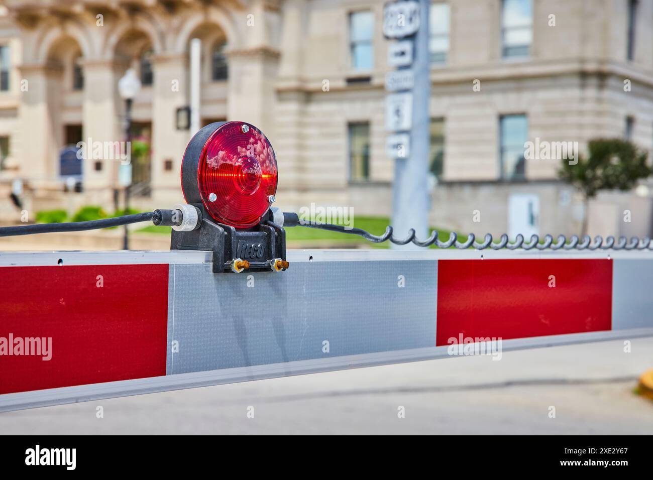 Red Warning Light on Barrier Fronting Courthouse Urban Eye-Level View ...