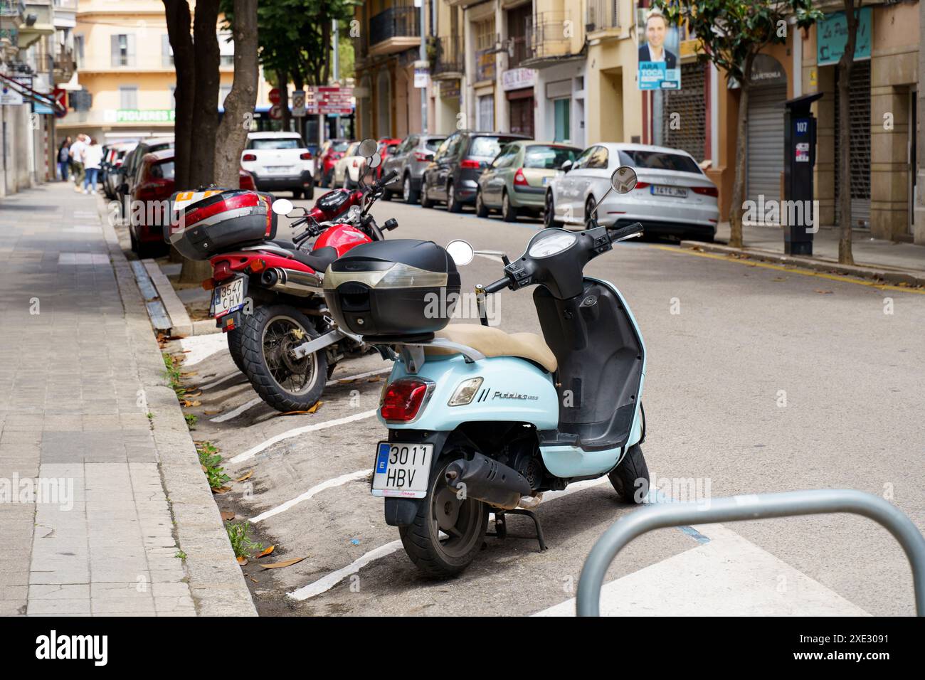 Figueres, Spain - May 14, 2023: A line of scooters neatly parked along ...