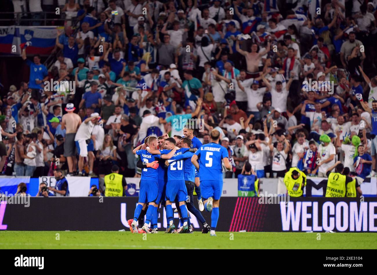 Slovenia players celebrate qualifying for the next round after the UEFA ...