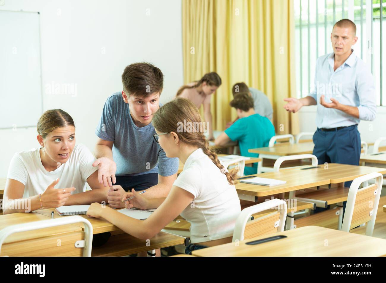 Fellow students having group work tasks during school Stock Photo - Alamy