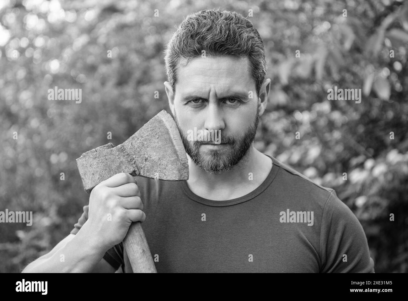 face of masculine guy with axe outdoor. photo of masculine guy with axe ...