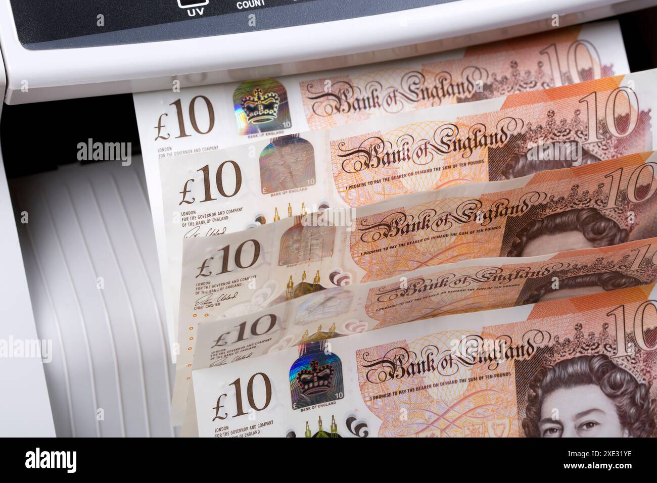 English pounds in a counting machine Stock Photo - Alamy