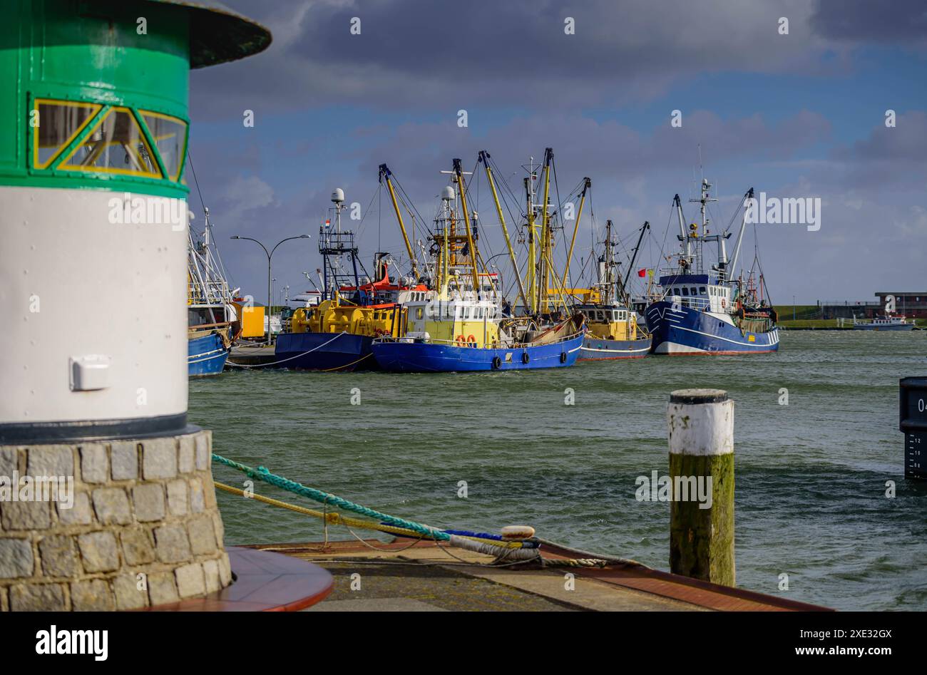 Green pier light and fishing boats moored in the fishing port of BÃ¼sum ...