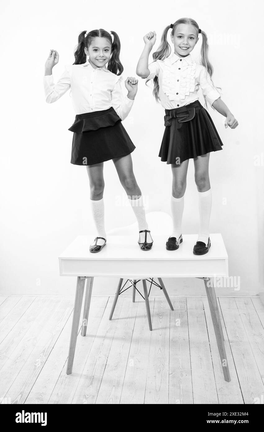 two girls in school uniform. education and knowledge. children girls ...