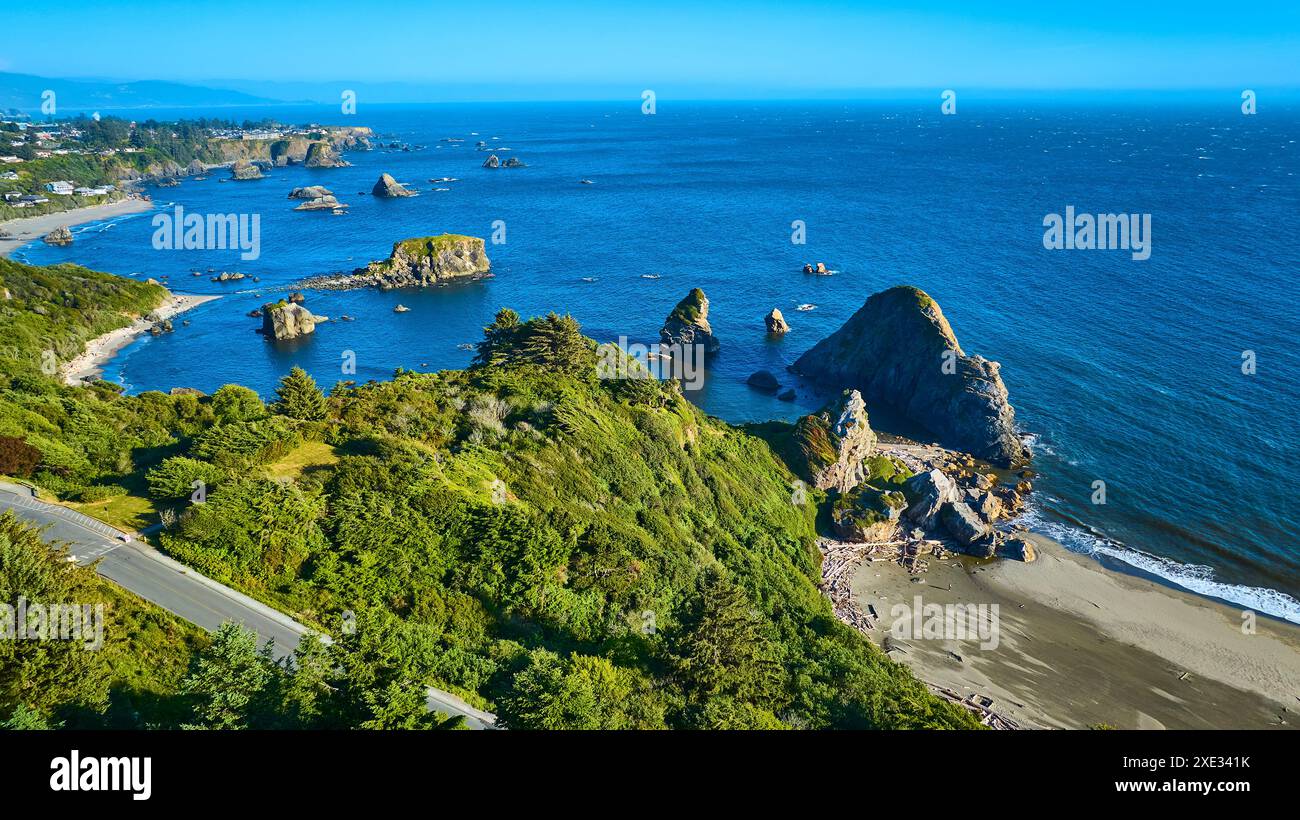 Aerial Fly Through Rugged Coastline and Forested Cliffs Stock Photo - Alamy