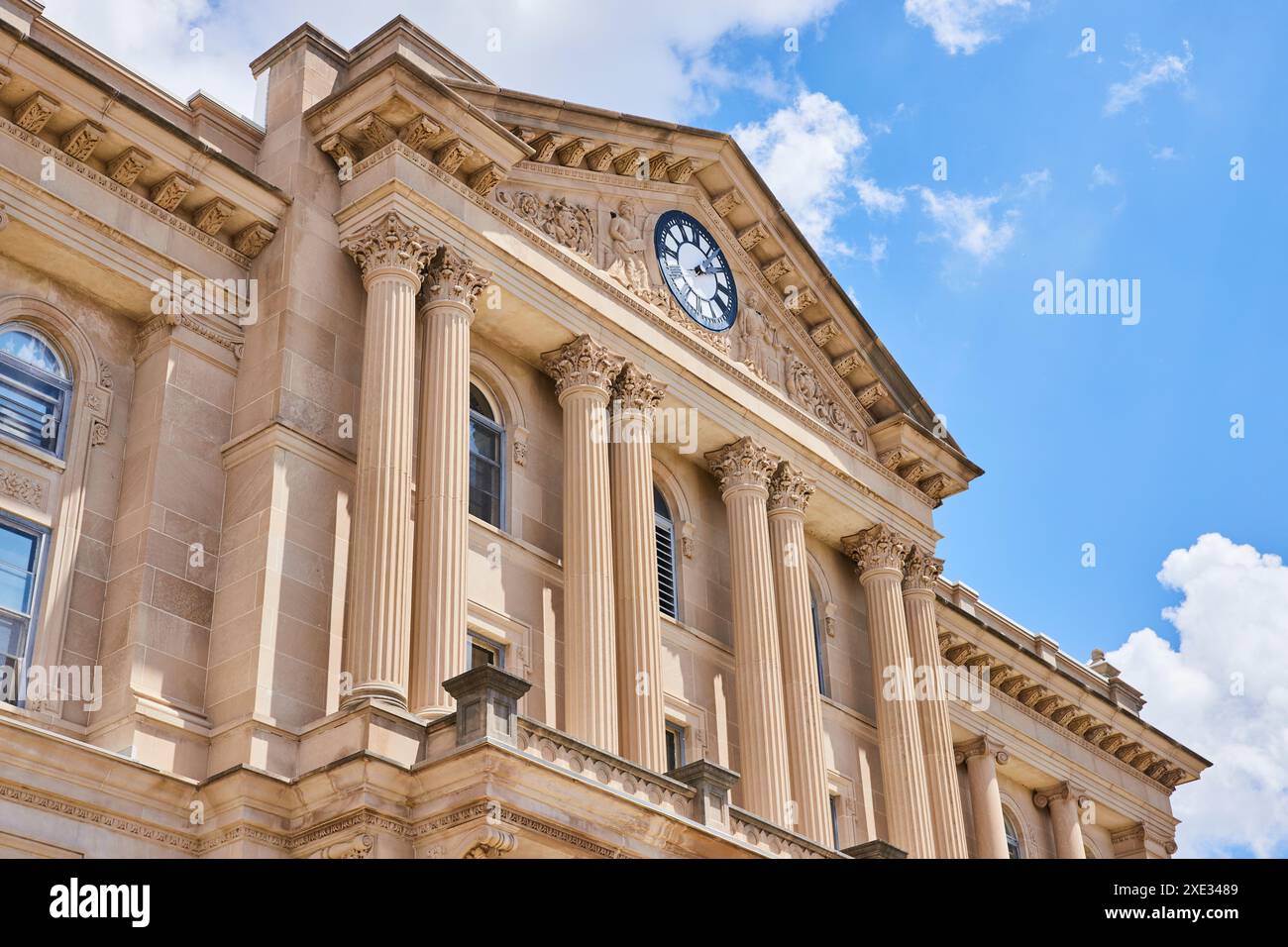 Neoclassical Courthouse Facade with Clock and Columns Low Angle View ...
