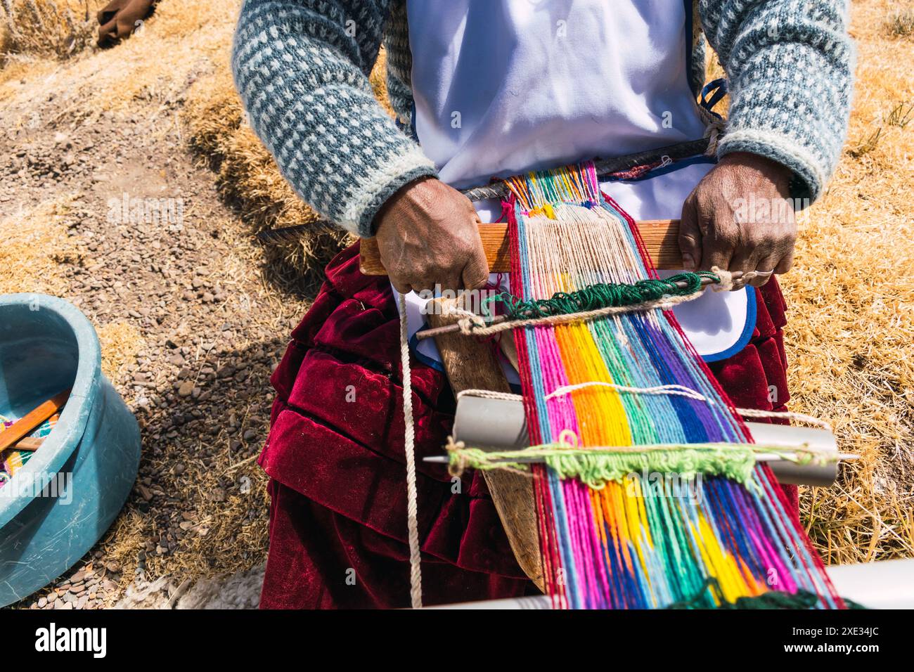 poor indigenous adult woman artisan with blue mask and typical ...
