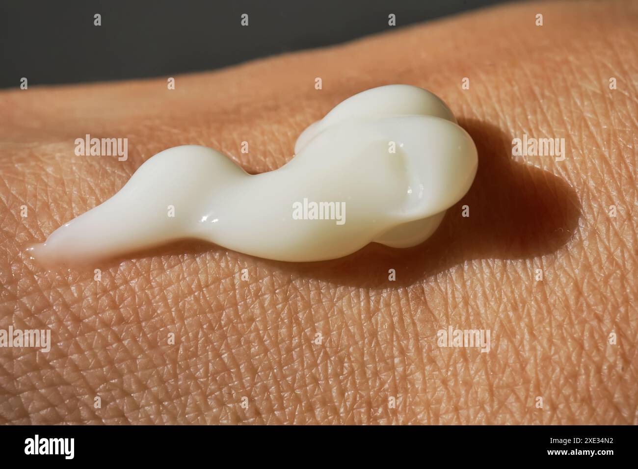 A smear of white moisturizer or sunscreen on a woman's hand Stock Photo ...