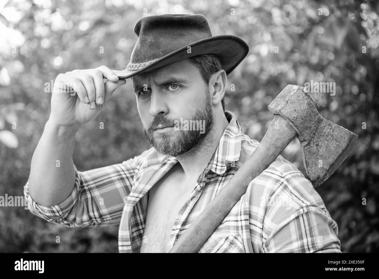 face of cowboy with axe. cowboy with axe wearing checkered shirt ...