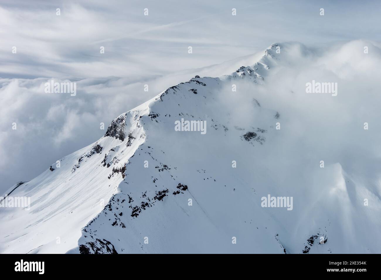 Flying over cold snowy mountain hi-res stock photography and images - Alamy