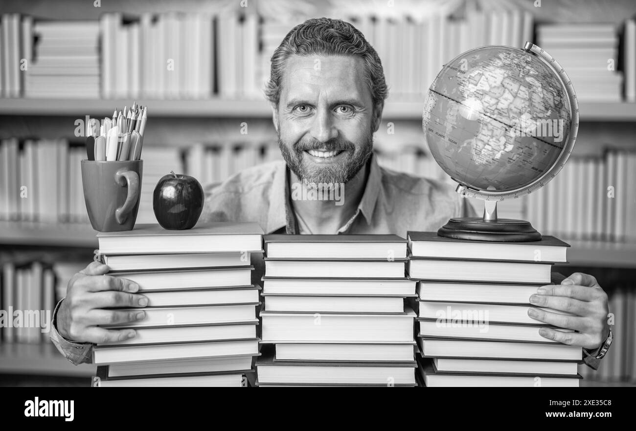 university teacher professor in school classroom library preparing for ...