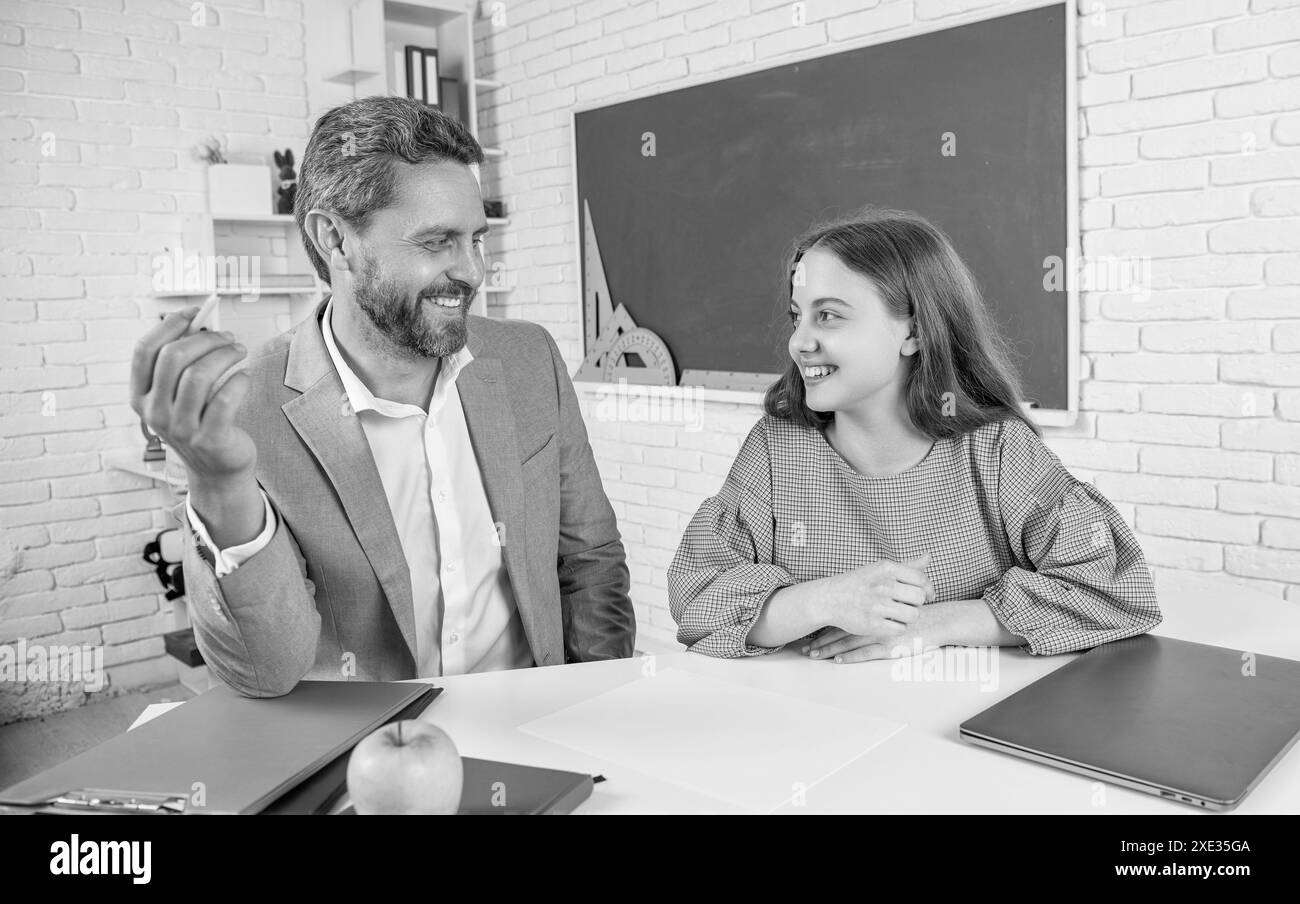 positive child study in classroom with tutor Stock Photo - Alamy