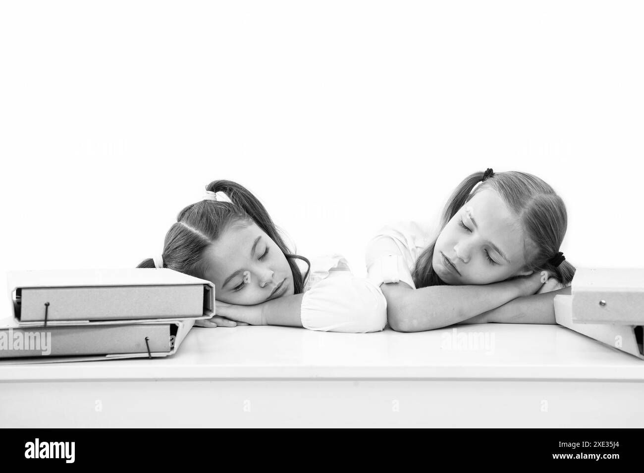 tired and sleepy. two girls in school class. education and knowledge ...