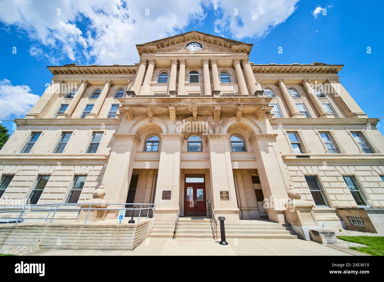 Classical Courthouse with Columns Under Clear Blue Sky Low Angle Stock ...