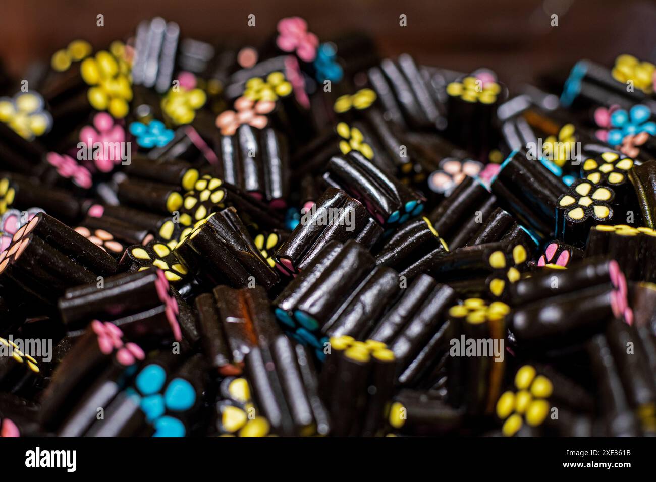 background of black chewing candies with licorice. medicinal sweets ...