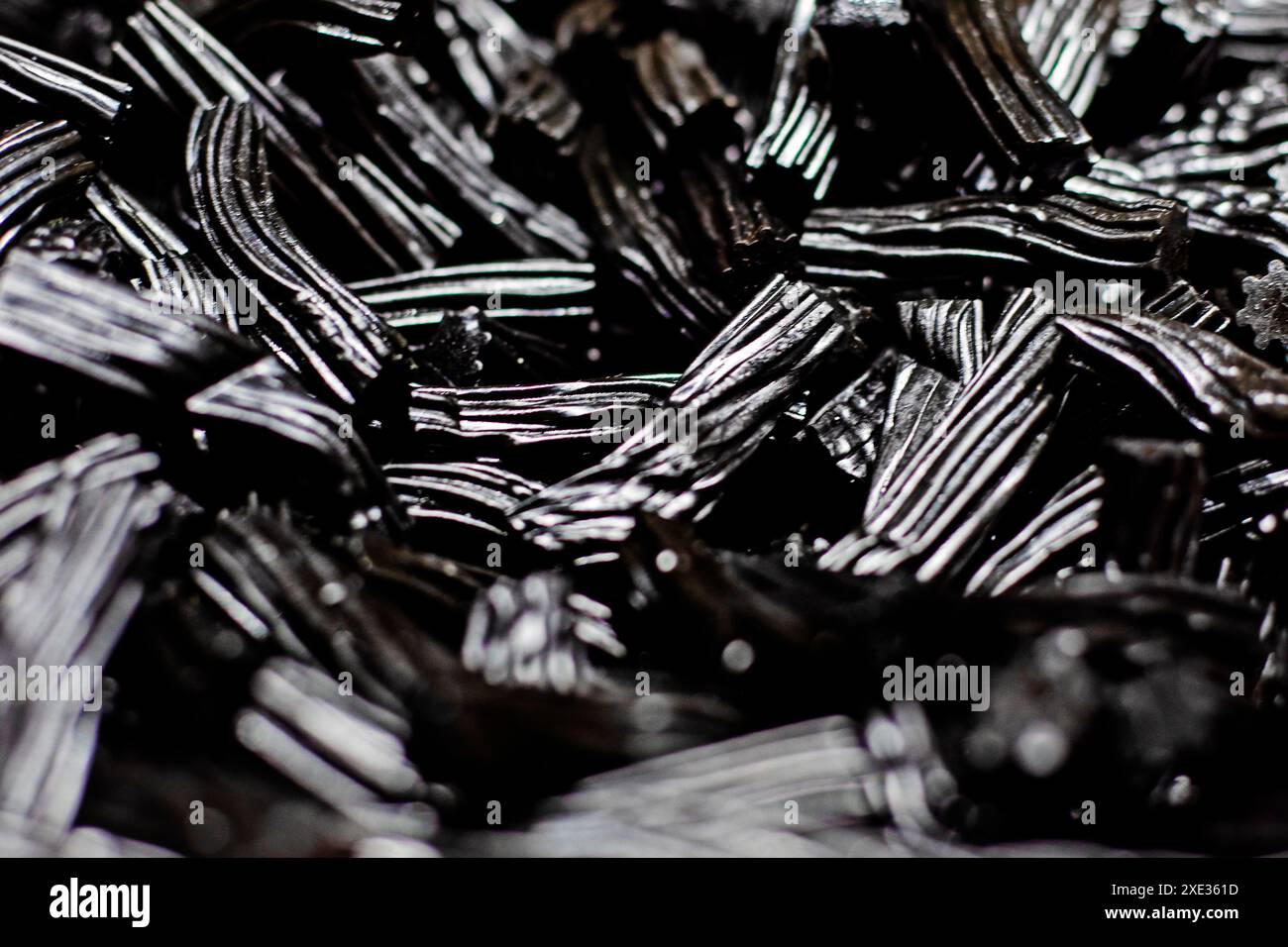 background of black chewing candies with licorice. medicinal sweets ...