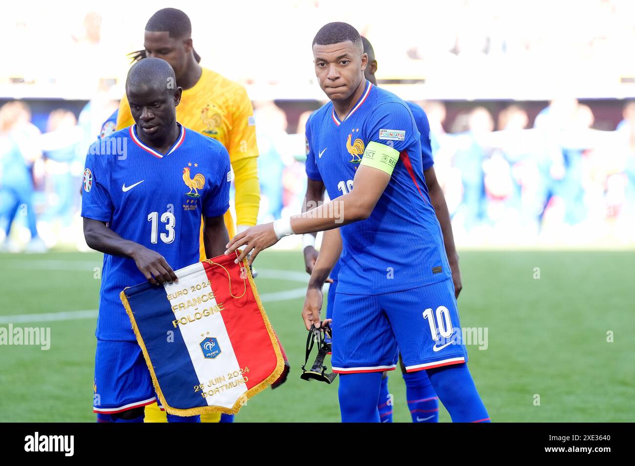 France's Kylian Mbappe (right), holding a protective black mask after ...