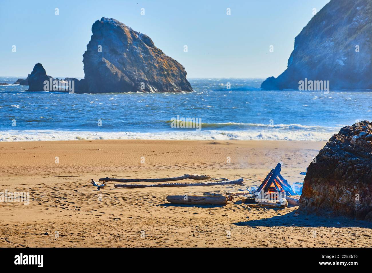 Campfire on Sandy Beach with Ocean Rock Formations at Eye Level Stock ...