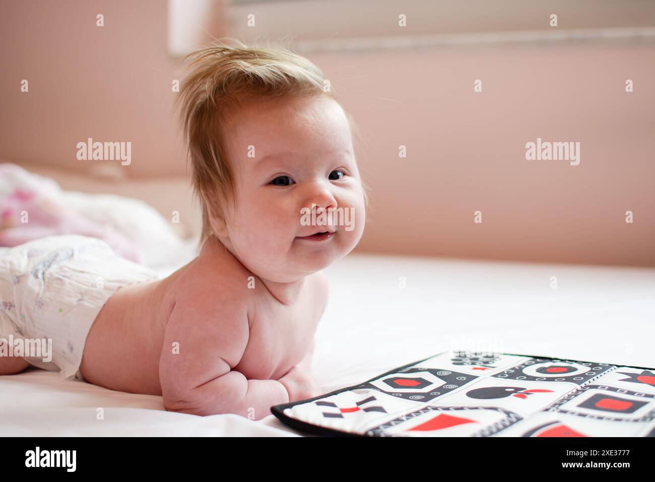 2-month-old newborn baby girl looking at high-contrast pictures during ...