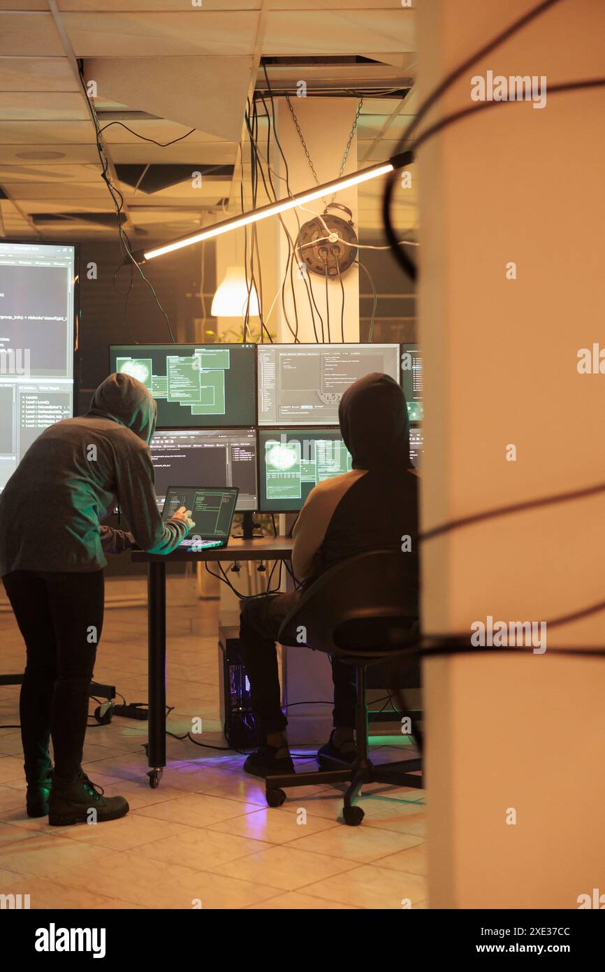 Team of people talking about getting illegal access into government database, working on ...