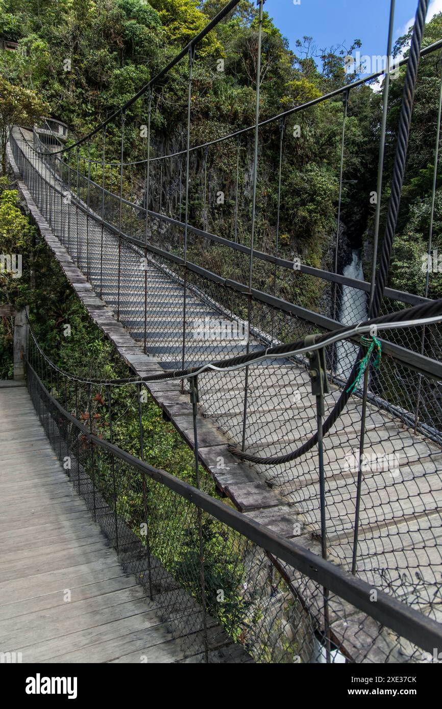 hanging wooden bridge located next to the majestic Pailon del Diablo ...