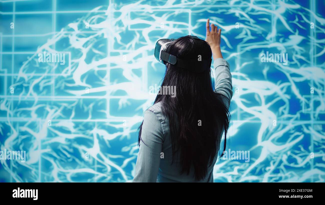Developer wearing VR headset looking at hologram of artificial ...