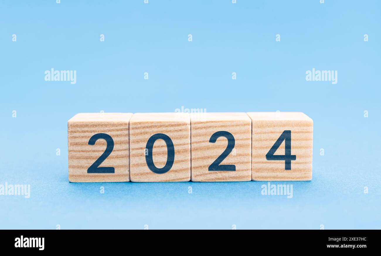 2024 on Wooden blocks isolated on blue background. Copy space Stock ...