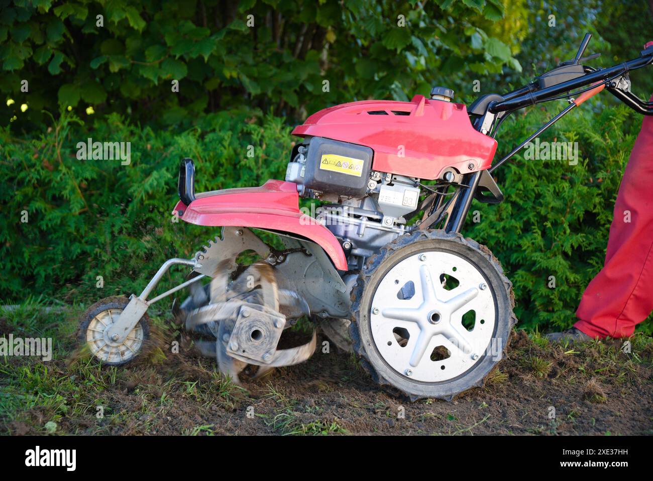 Gardener with motor hoe while tilling and landscaping Stock Photo - Alamy