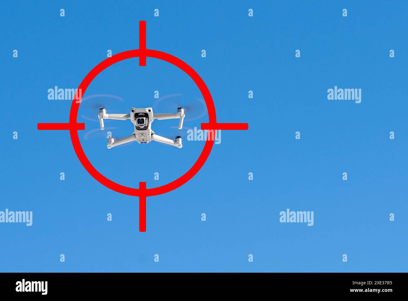 Gun sight pointing at drone flying against blue sky. Concept of flight ...