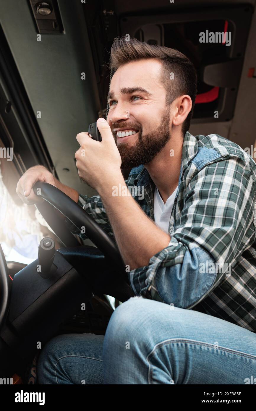 Truck driver talking by CB radio system in his vehicle Stock Photo - Alamy