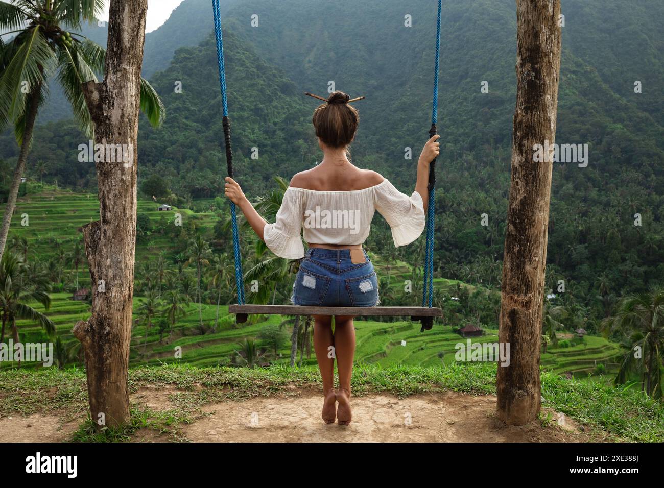 Woman on rope swings with beautiful view on rice terraces in the Bali ...
