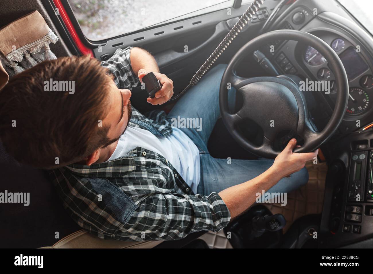 Truck driver talking by CB radio system in his vehicle Stock Photo - Alamy