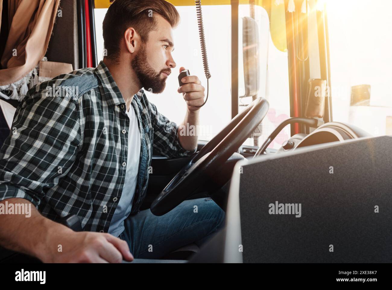 Truck driver talking by CB radio system in his vehicle Stock Photo - Alamy