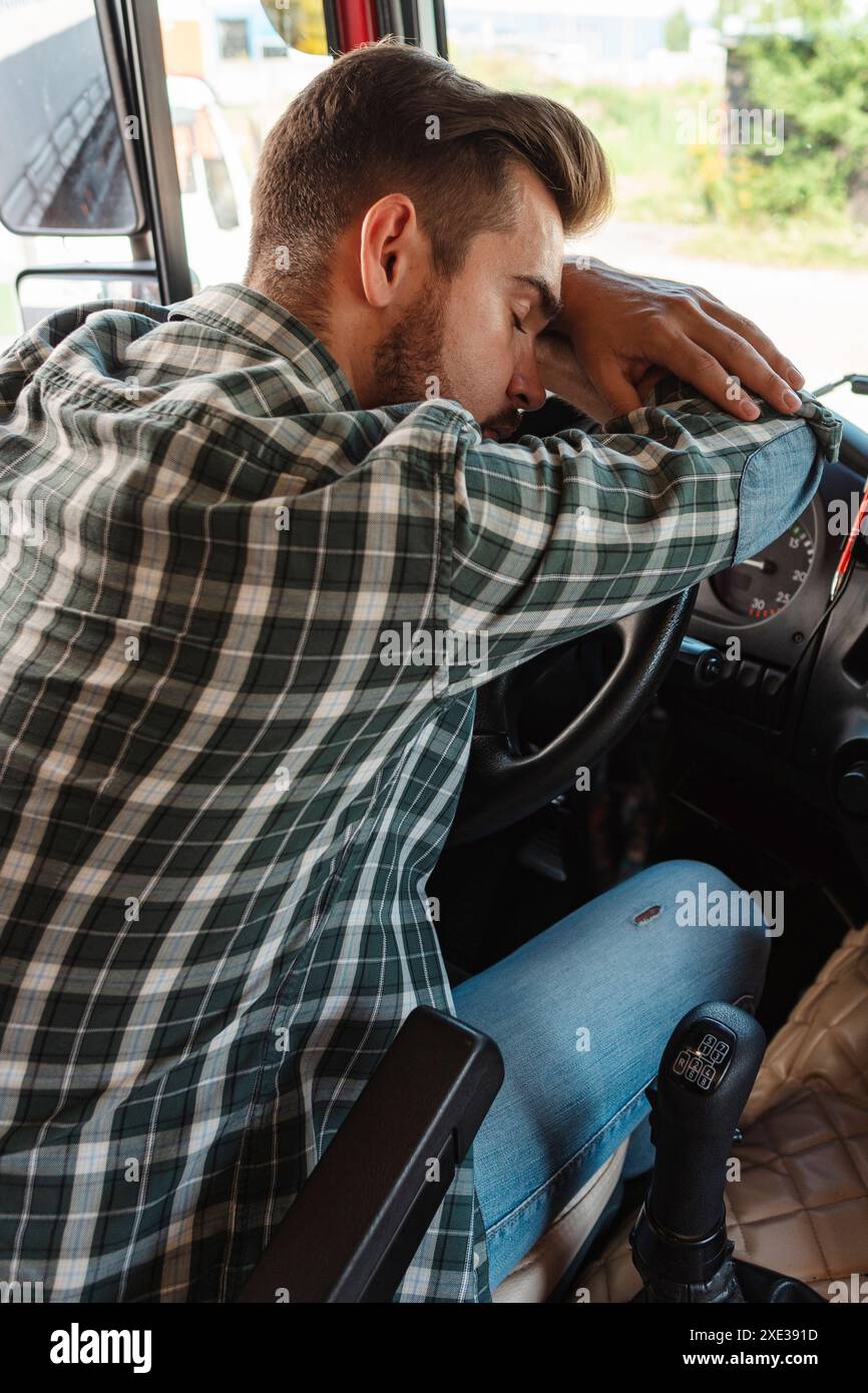 Tired truck driver feeling sleepy and sick Stock Photo - Alamy