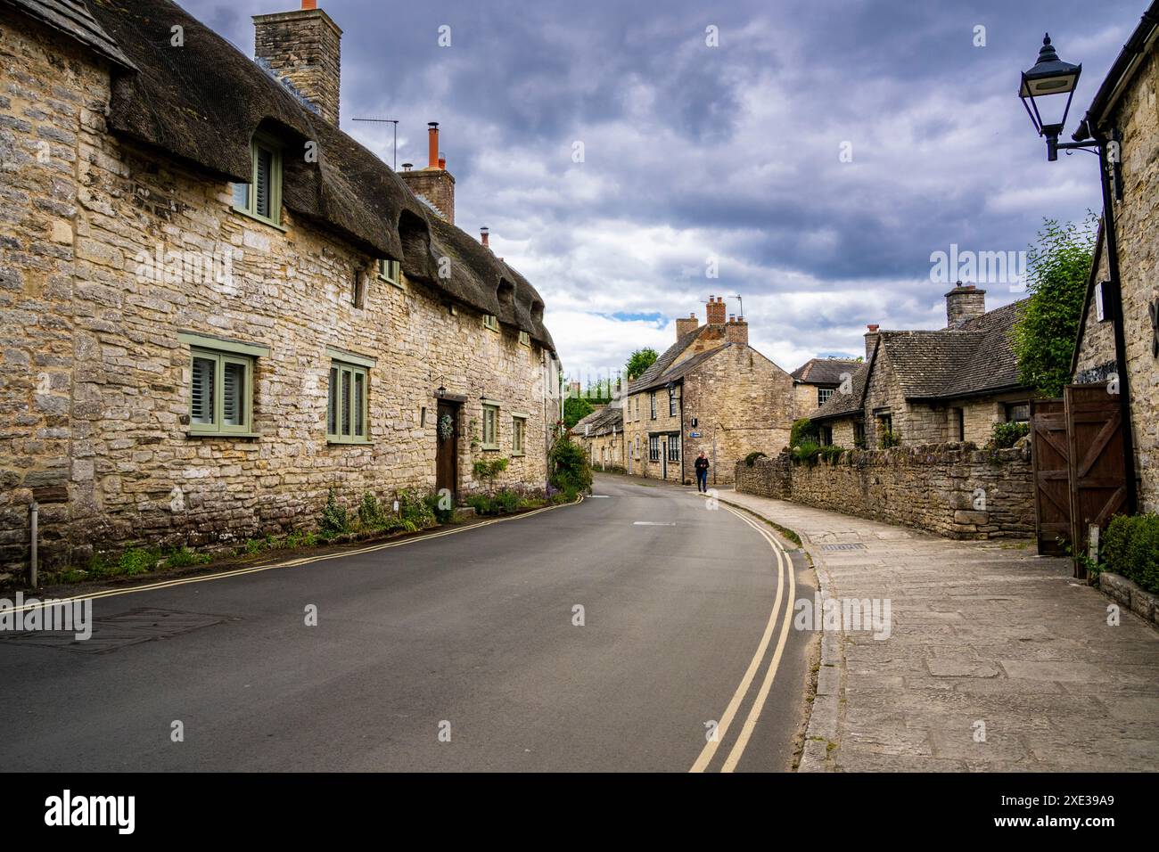 View along West Street in Corfe Castle village with old stone cottages ...
