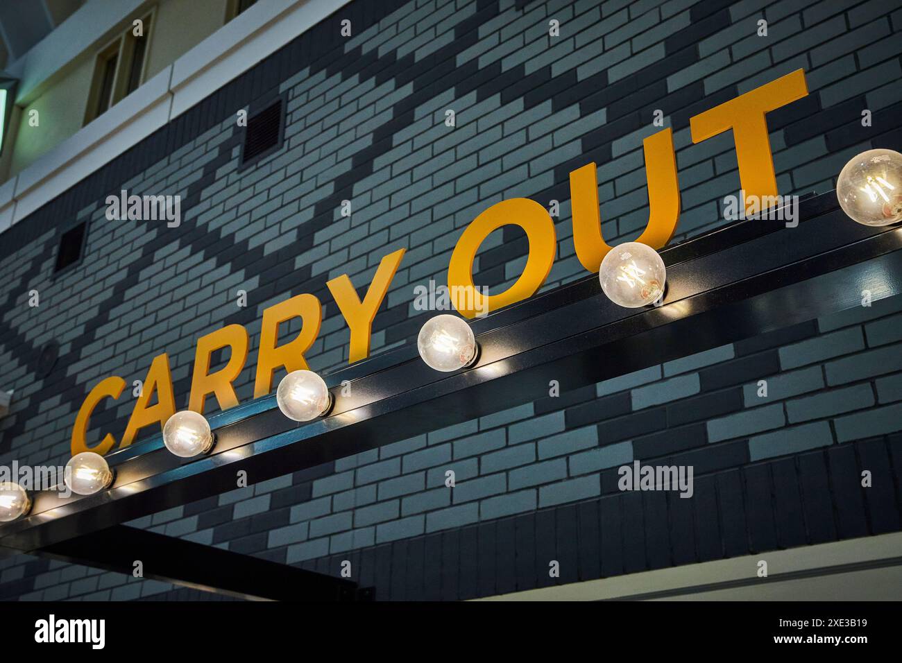 Modern Carry Out Sign on Brick Wall with Warm Night Lighting Low Angle ...
