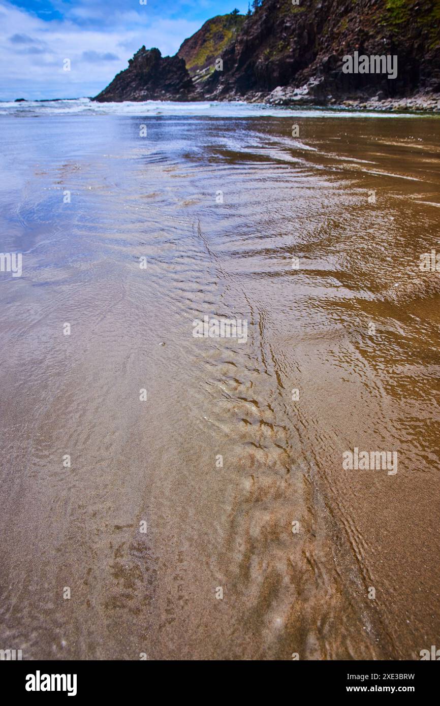 Secluded Beach and Rugged Cliffs with Receding Tides from Low Angle ...
