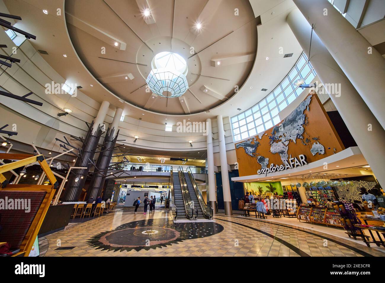 Modern Shopping Mall Interior with Travel-Themed Store and Escalator ...