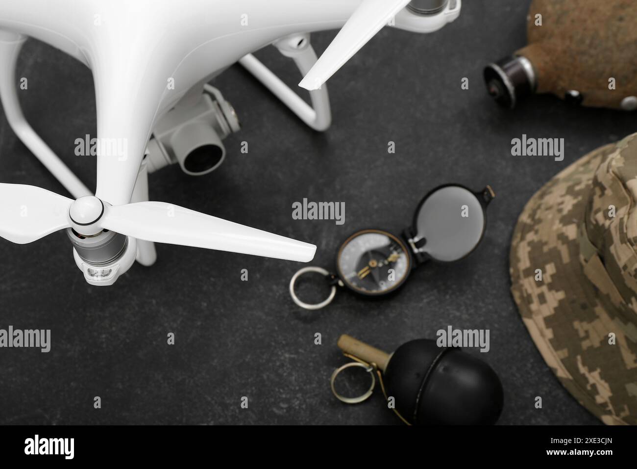 Modern quadcopter, grenade, military hat, flask and compass on black ...