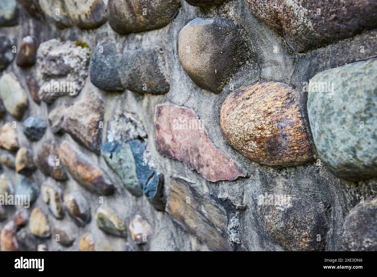 Varied Stone Wall Close-Up with Rust-Colored Boulder Stock Photo - Alamy